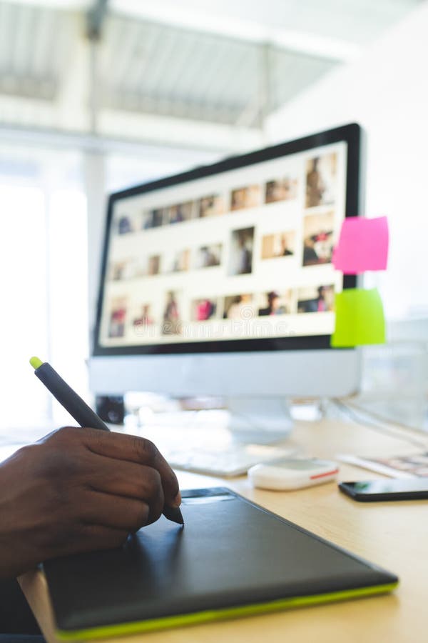 Graphic Designer Working on Graphic Tablet and Computer at Desk in ...