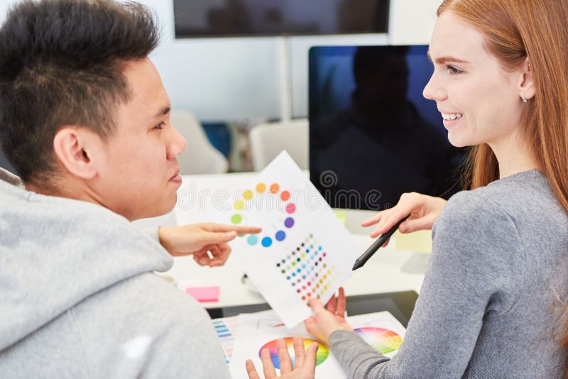 Graphic Designers Discuss an Idea for Color Design Stock Photo - Image ...