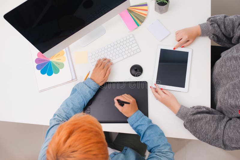 Graphic Designers Discussing Over Computer in Modern Office Stock Photo ...
