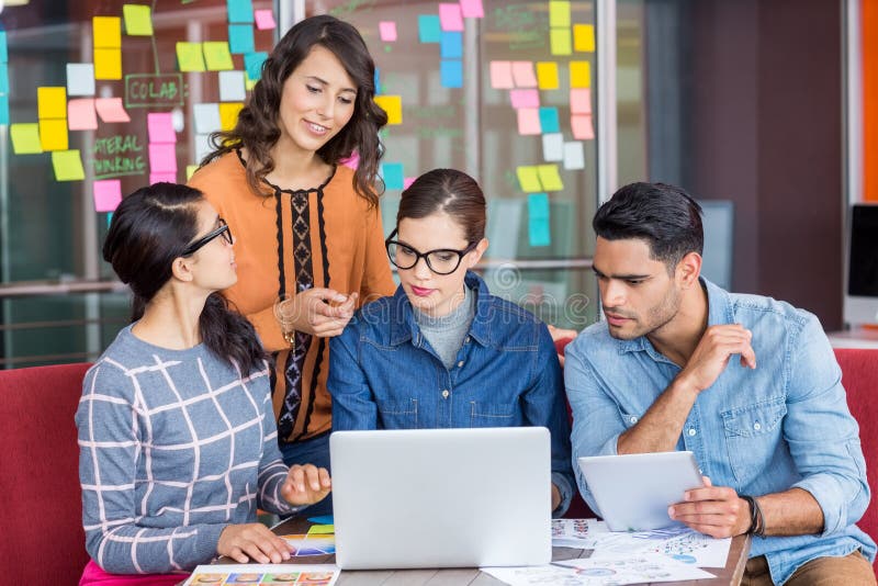 Graphic Designers Discussing Over Laptop Stock Photo - Image of female ...
