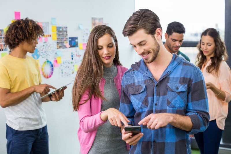 Graphic Designers Using Mobile Phone Stock Image - Image of friend ...