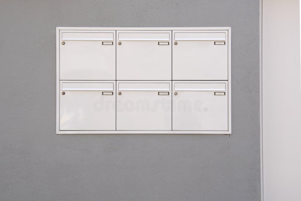 Graphic View of White Mailboxes on a Grey Wall of a House Stock Photo ...