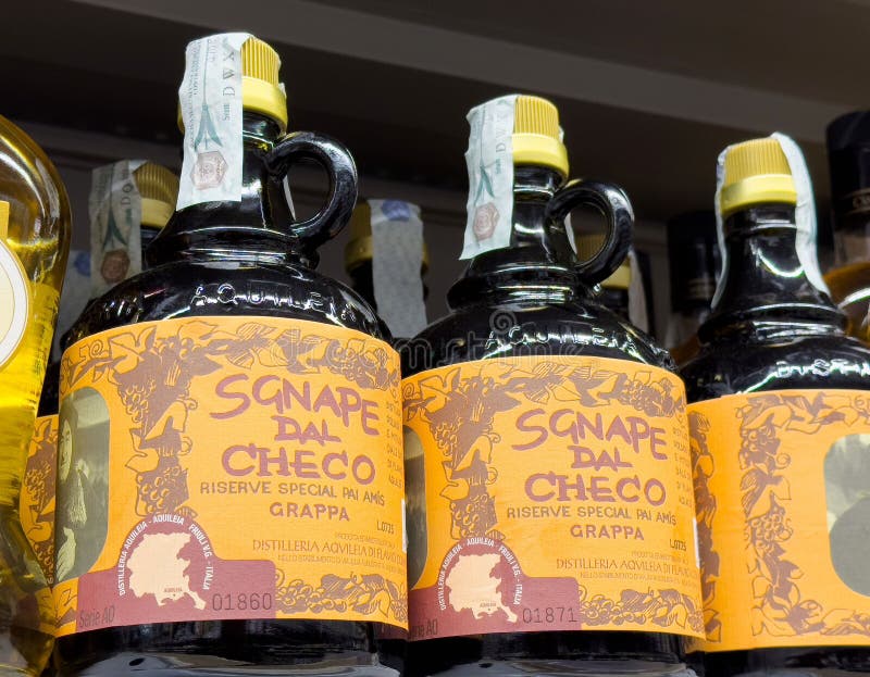 Grappa Bottles on Store Shelf with Distinctive Labels and Tax Stamps ...