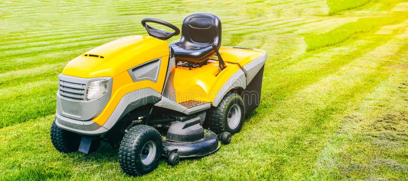 Grass Cutter in the Work. Machine for Cutting Lawn is Standing Outdoors ...