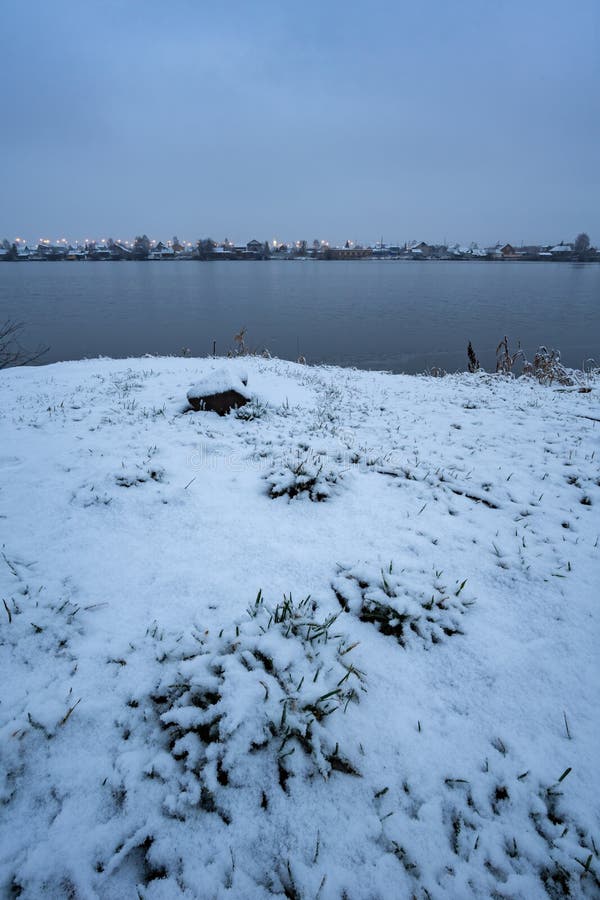 Grass with a Song of Snow Against the Background of the Lake Stock ...