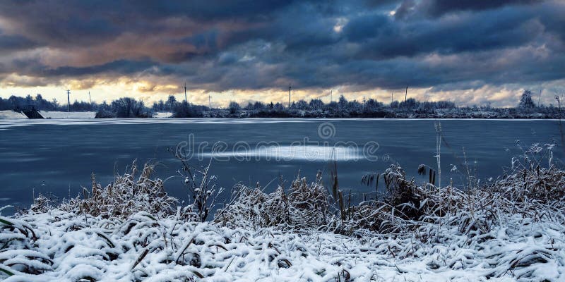 Grass with a Song of Snow Against the Background of the Lake Stock ...