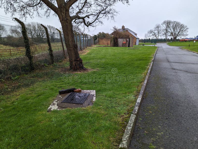 Grassy Field with a Manhole and Building in Wales Stock Photo - Image ...