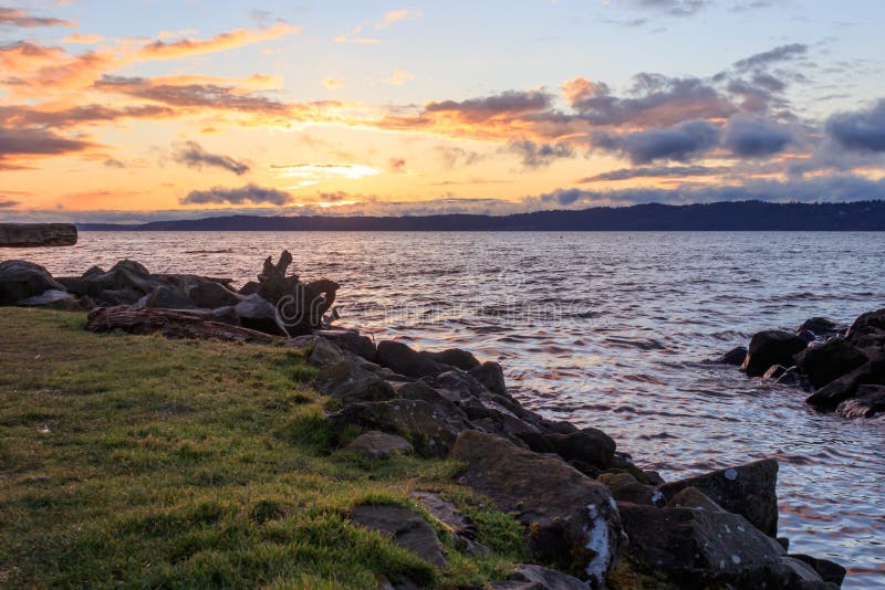 Grassy Cliff Overlooking Water Stock Image - Image of horizon, island ...