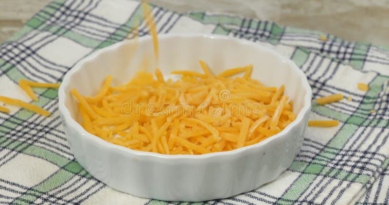 Grated Cheddar Cheese Falling into a Bowl Stock Video - Video of ...
