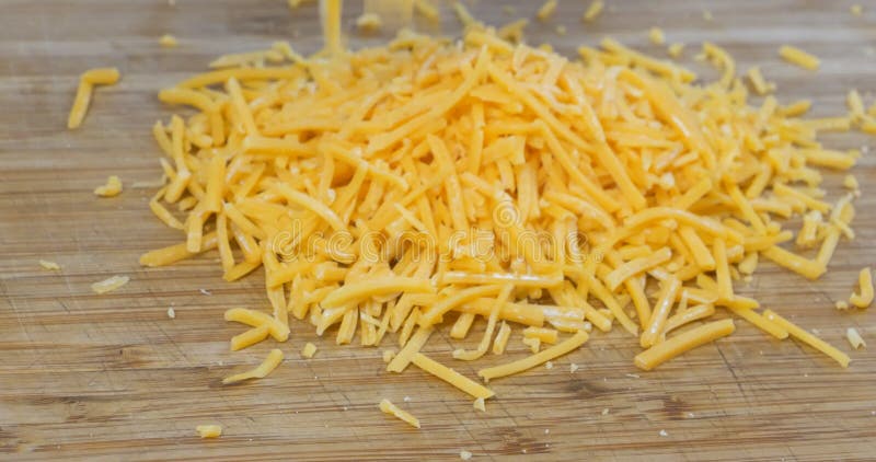 Grated Cheddar Cheese Falling into a Mound Close Up. Stock Video ...
