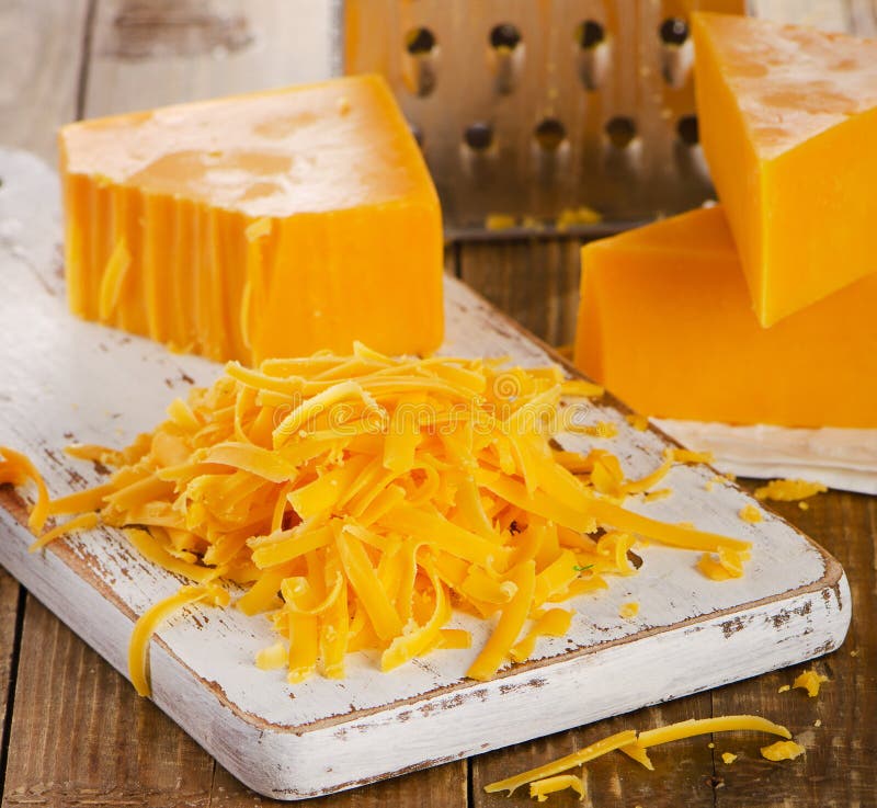 Block and Grated Cheddar Cheese Stock Photo - Image of shred, crumbling ...