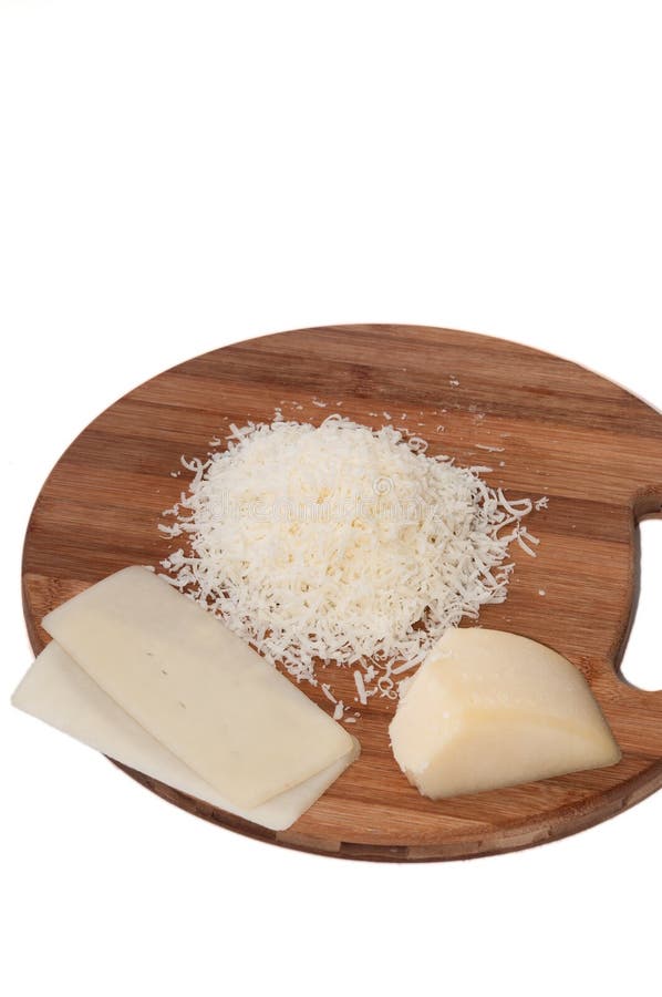 Grated Cheese on a Kitchen Wooden Board and Cheese in One Piece Stock ...
