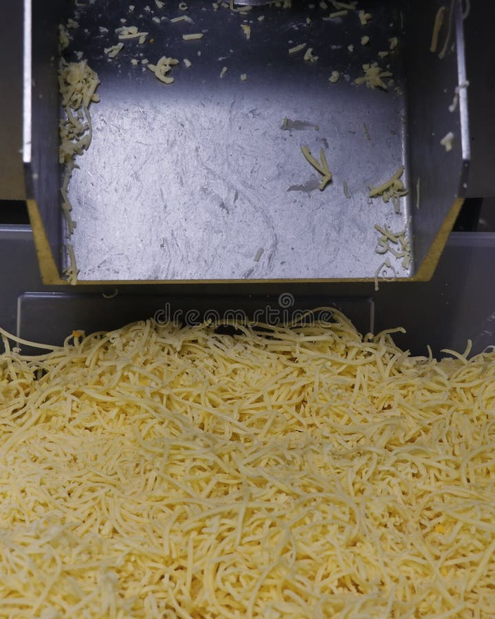 Grated Cheese Making with Electric Grater Machine Stock Photo - Image ...