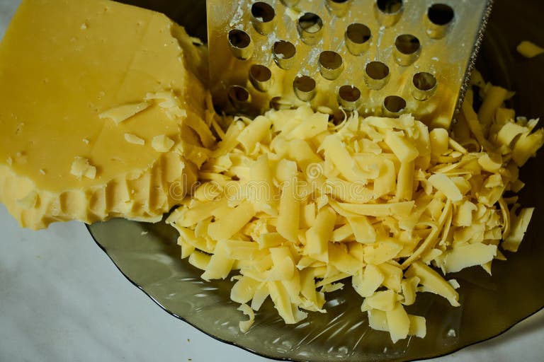 Grated Cheese on Red Grater in Kitchen Bowl Stock Image - Image of ...