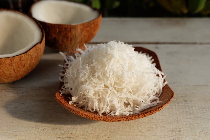 Grated Coconut and Half Cut Coconut on Wooden Floor Stock Photo - Image ...