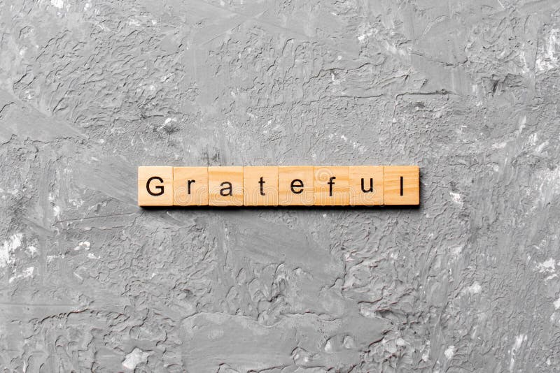 Grateful Word Written on Wood Block. Grateful Text on Table, Concept ...