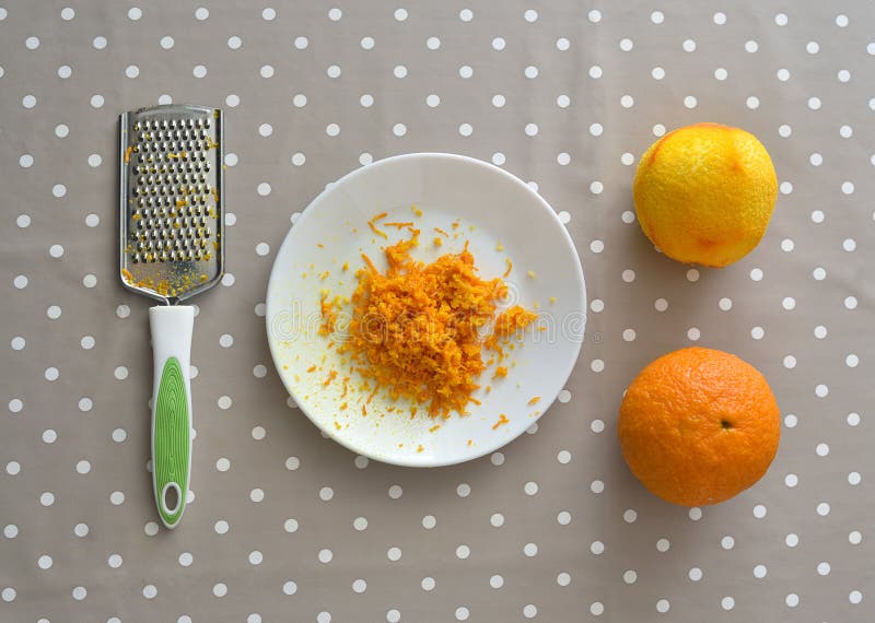 Grater and Plate with Ripe Orange and Zest on the Table Stock Image ...