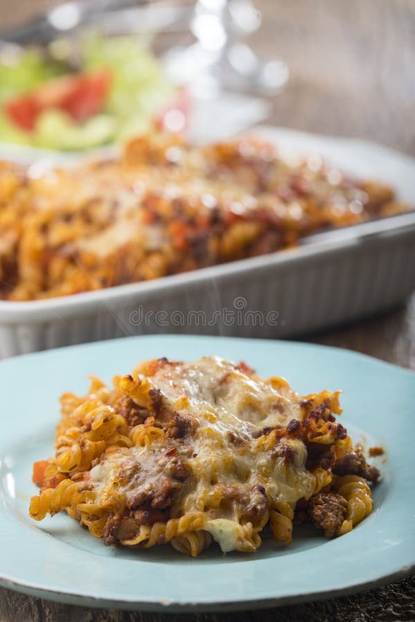 Gratinated pasta on wood stock image. Image of cheese - 213916739