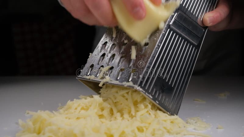 Grating cheddar cheese stock footage. Video of closeup - 278229894