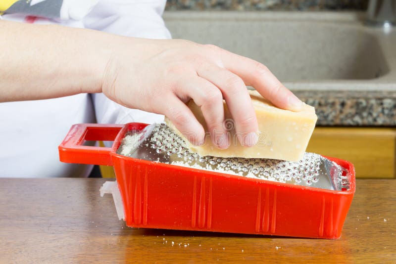 Grating Parmesan cheese stock photo. Image of meal, preparation - 53829694