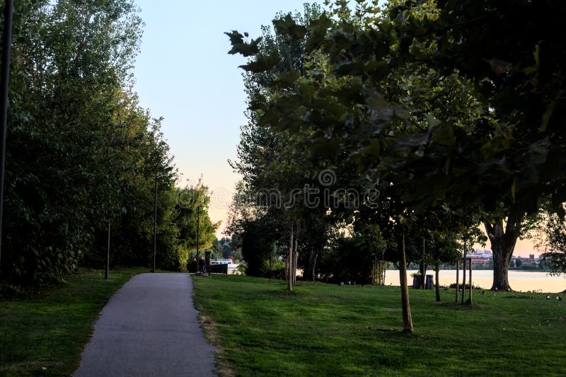 Gravel Path in a Park Next To a Lake at Sunset Stock Photo - Image of ...