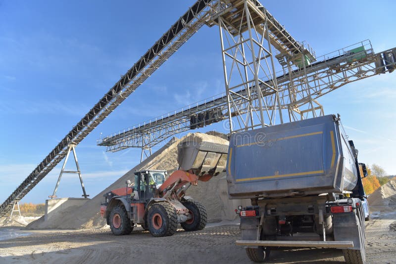 Gravel Pit: Building and Wheel Loader Loading Gravel Onto a Truck Stock ...