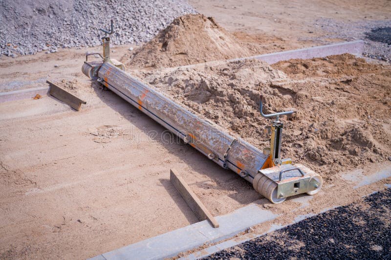 Gravel is Pulled Straight with a Small Machine To Lay Paving Stones ...