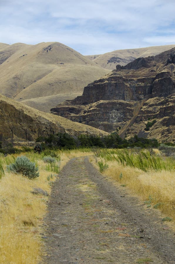 Gravel road through desert stock photo. Image of environment - 71542068