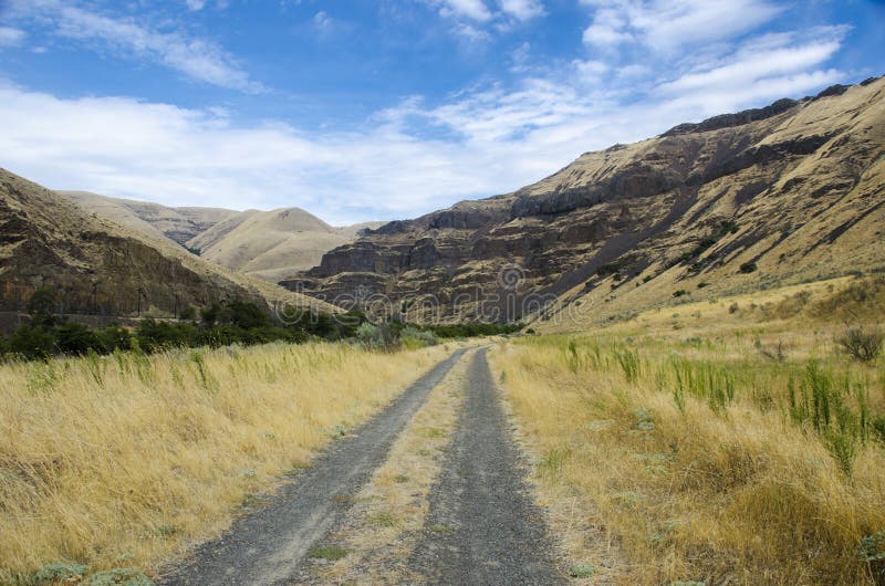 Gravel road through desert stock image. Image of terrain - 71542069