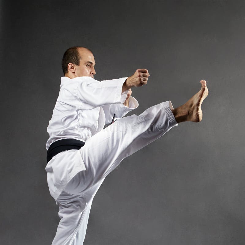 On a Gray Background, the Athlete Beats Kick Leg in Karategi Stock ...