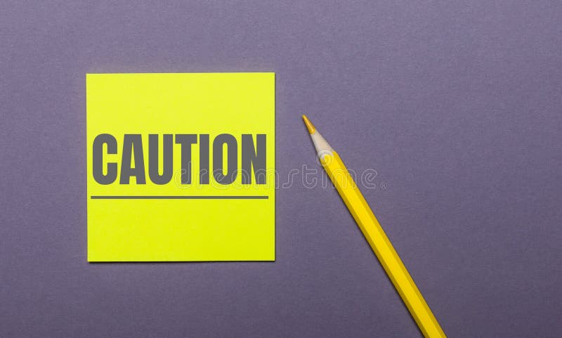 On a Gray Background, a Bright Yellow Pencil and a Yellow Sticker with ...
