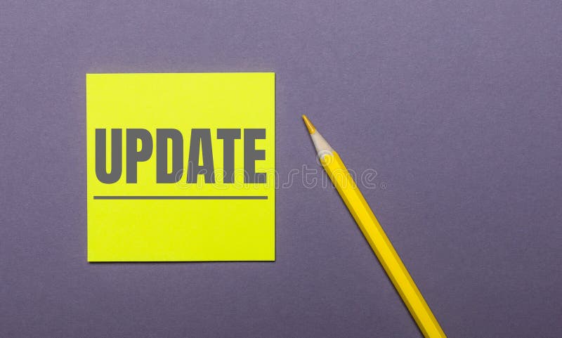 On a Gray Background, a Bright Yellow Pencil and a Yellow Sticker with ...