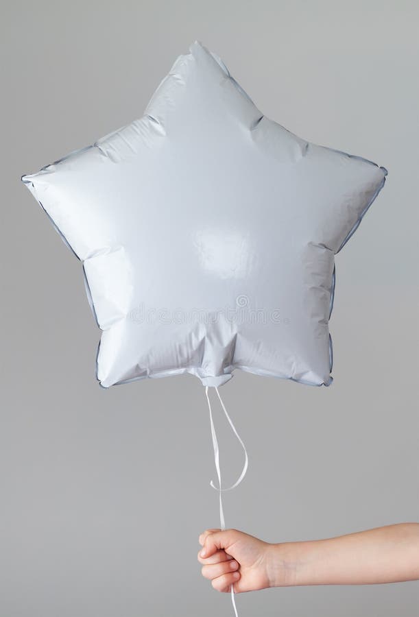 Gray Balloon in the Shape of a Star in the Hand Stock Photo - Image of ...