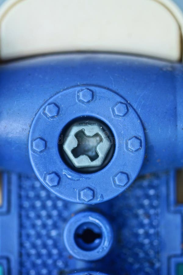 Gray Bolt Screwed into a Piece of Blue Plastic Toy Stock Photo - Image ...