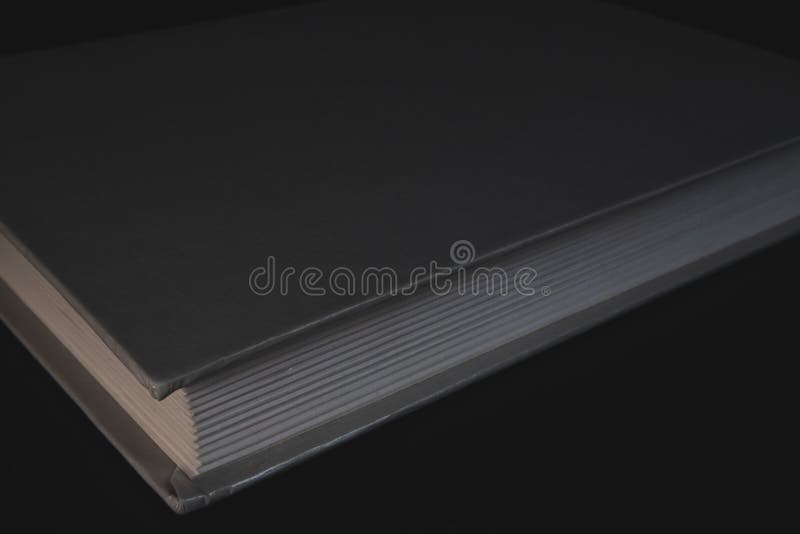 Gray Book with Dark Covers in the Dark on a Black Background Stock ...