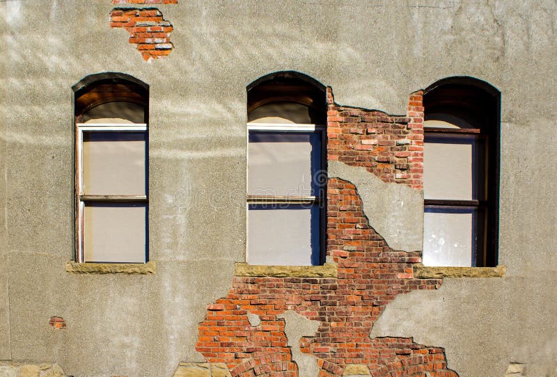Gray Cement Building with Three Windows and Exposed Red Bricks Stock ...
