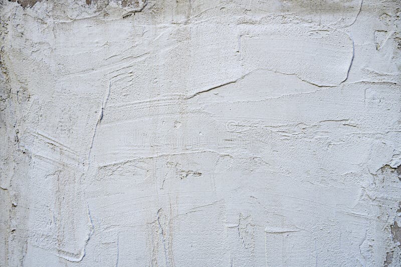 A Gray Cement Wall with Layers of White Plaster Carelessly Troweled ...