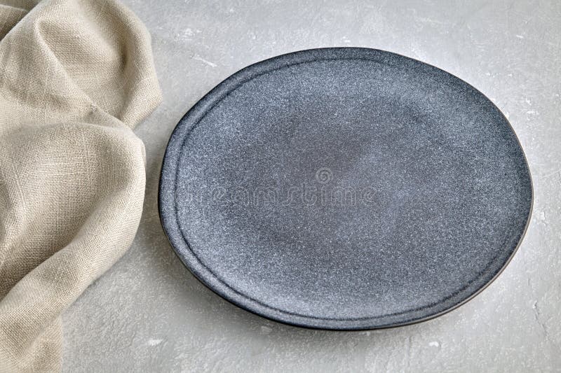 Gray Ceramic Plate and Kitchen Tablecloth on Gray Concrete Table. Top ...