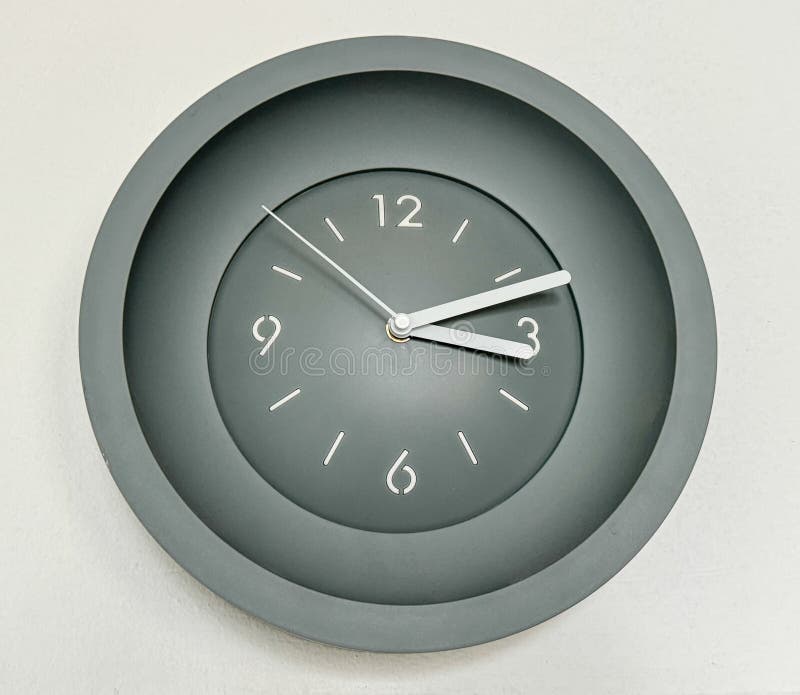 Gray clock on a white wall stock photo. Image of watch - 299661786