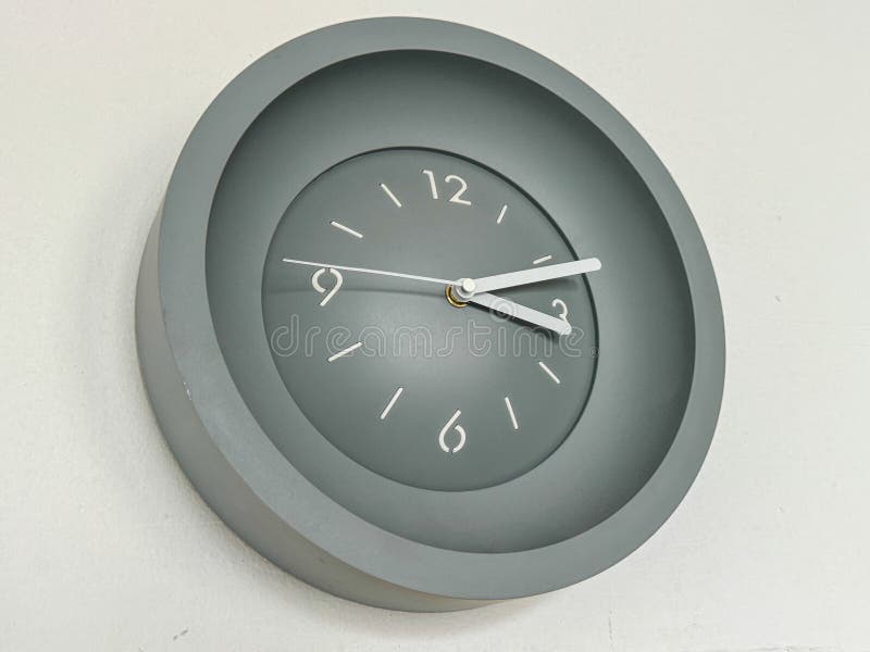 Gray clock on a white wall stock photo. Image of deadline - 299939126