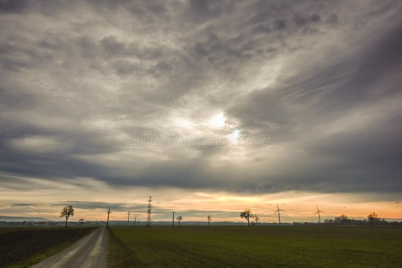 Gray Clouds on the Sky with Sun in a Flat Landscape with Windmills Stock Image - Image of ...