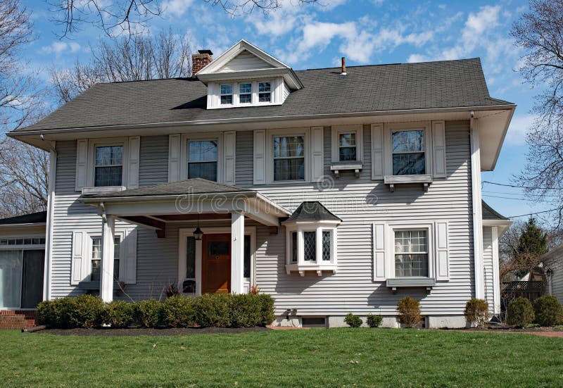 Tan Colonial House in Spring Stock Photo - Image of housing, blooming ...