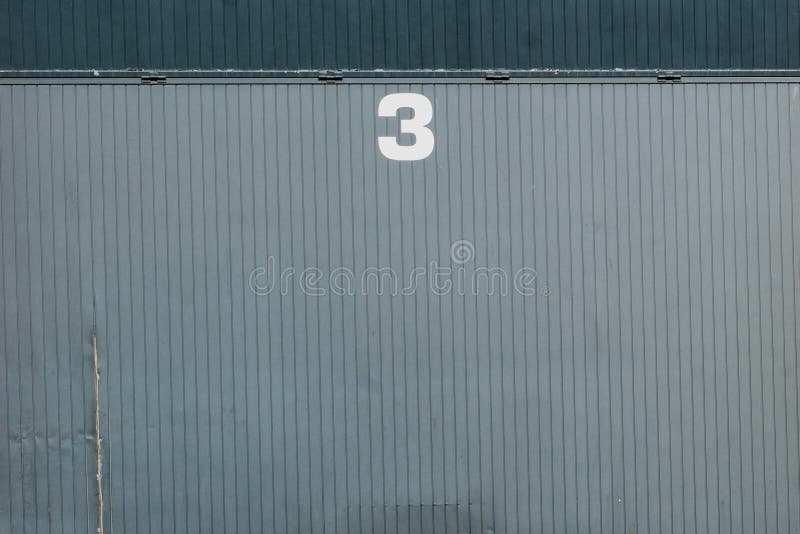 Gray Corrugated Metal Door with the Number Three in White Stock Image ...