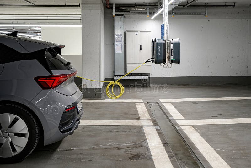 A Gray Electric Car is Charging in an Underground Parking. the Concept ...