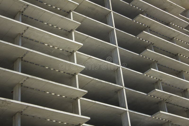 Gray Facade of a Concrete High-rise Unfinished Building. Intersecting ...