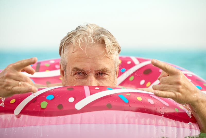Gray-haired Man Swims on an Inflatable Circle in the Sea Stock Photo ...