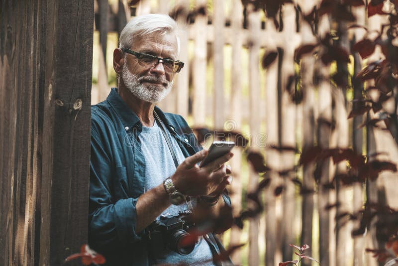 Gray-haired Influencer Man with a Phone, Communication for Old People ...