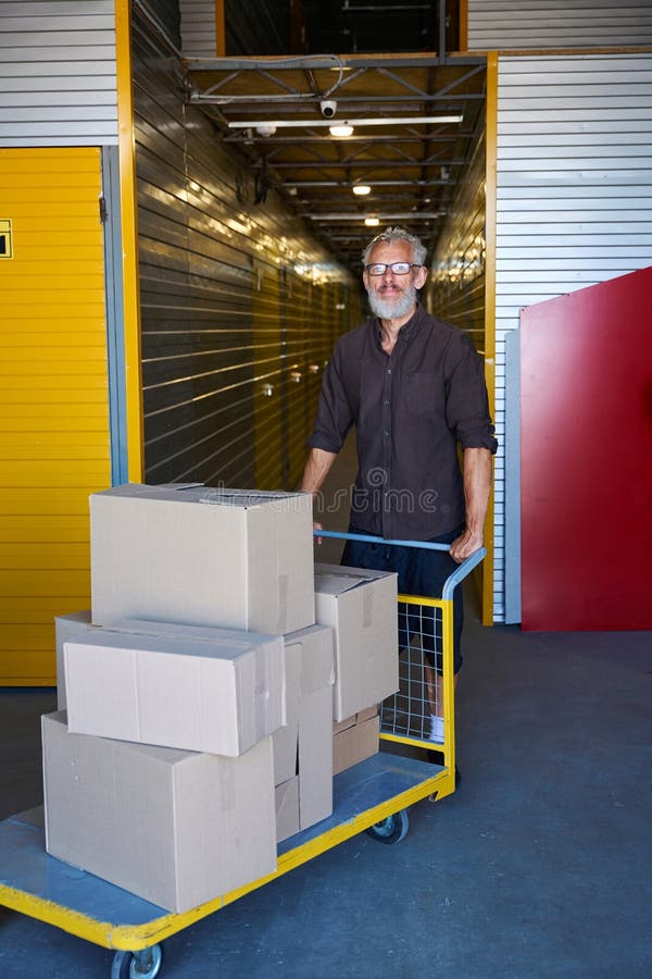 Gray-haired Man is Carrying Lot of Boxes on Cargo Cart Stock Photo ...