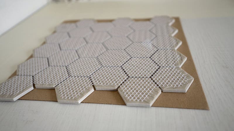 Gray Hexagonal Tiles Installation Process on Cardboard Stock Image ...