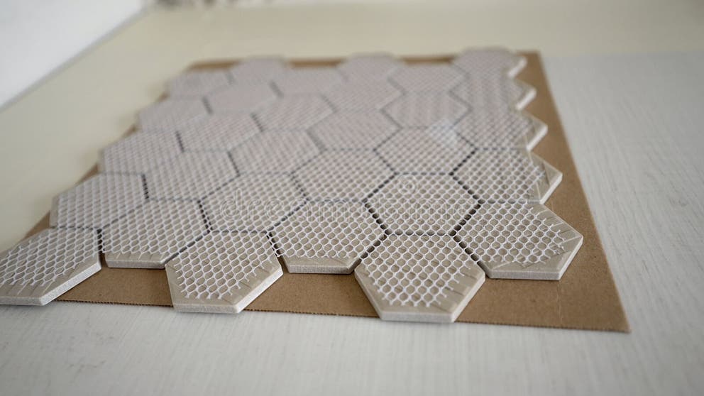 Gray Hexagonal Tiles Installation Process on Cardboard Stock Image ...